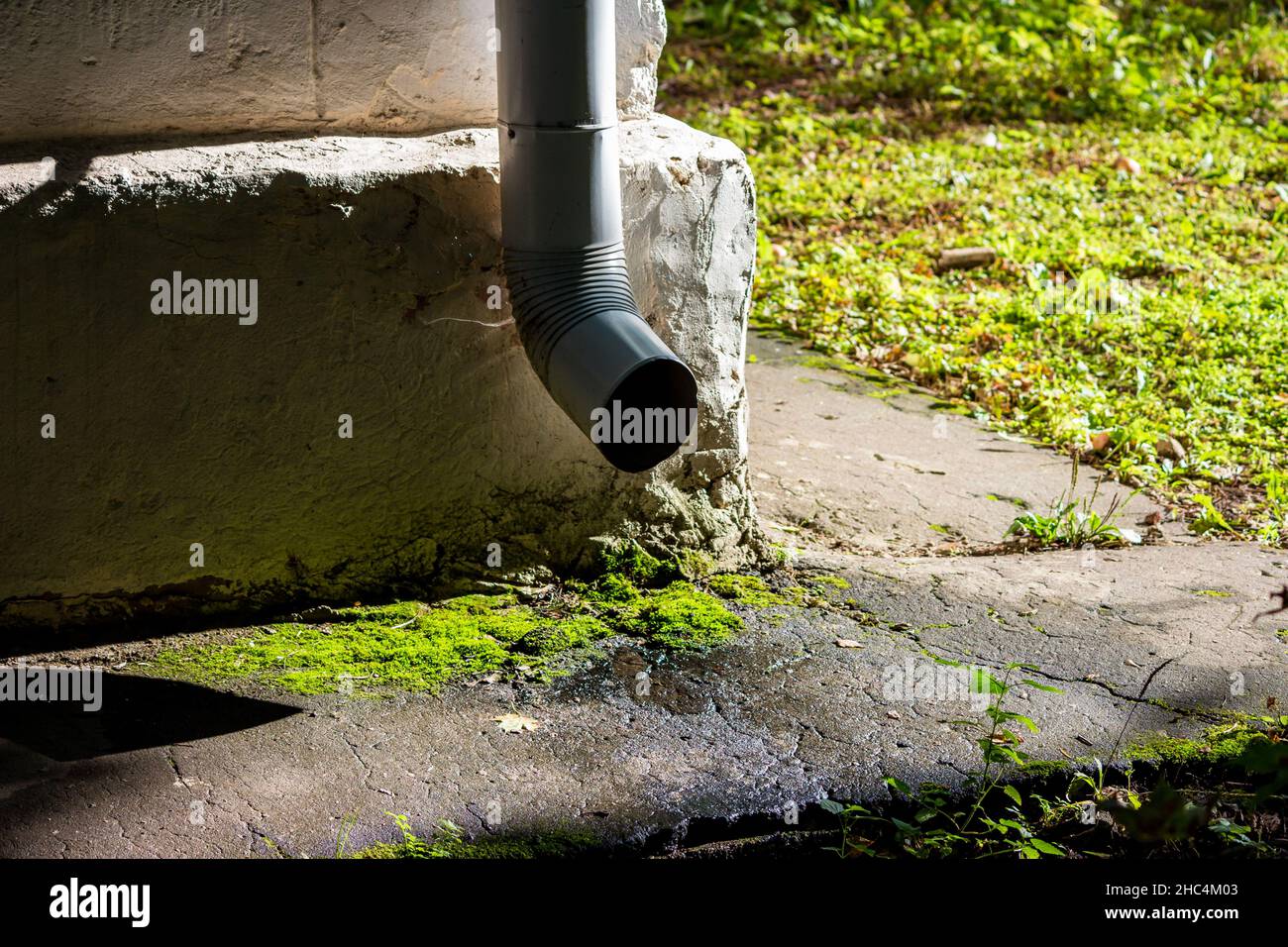 Metal downpipe at the corner of the house Stock Photo - Alamy