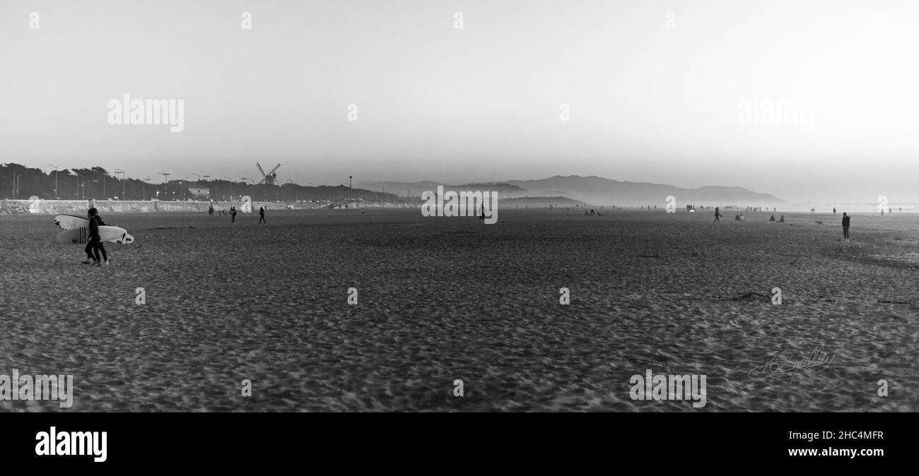 Grayscale shot of people on the beach in San Francisco, USA Stock Photo ...