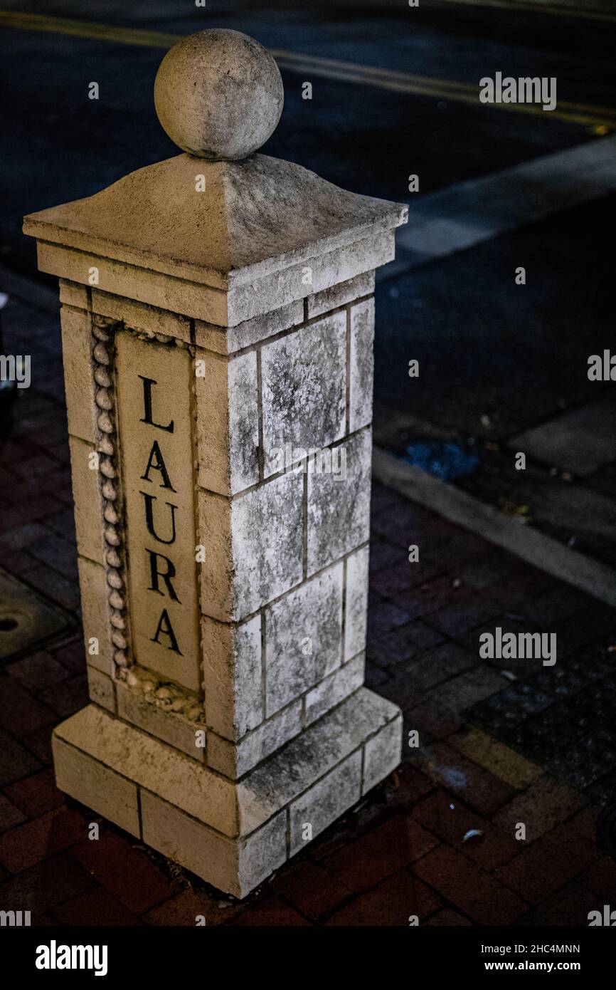 Vertical shot of a stone structure with a "Laura" writing in ...