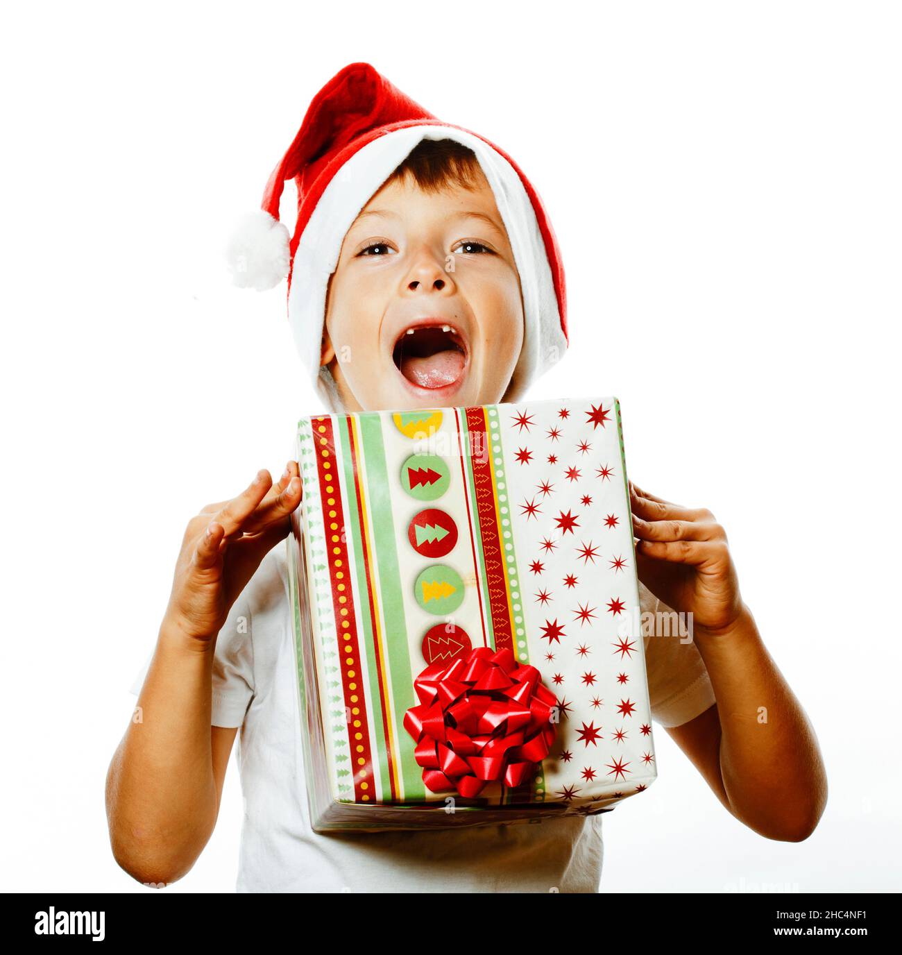 young pretty boy in santas red hat isolated on white background holding ...