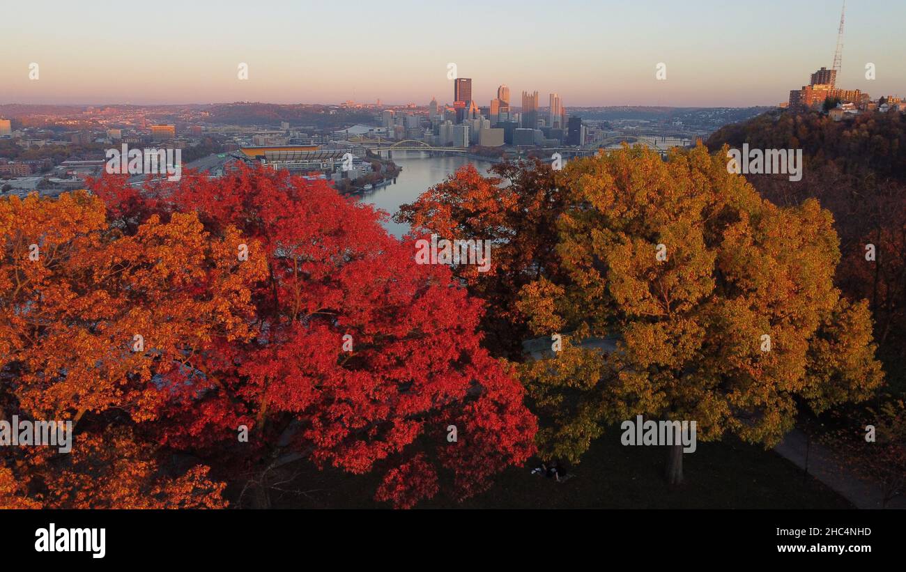 Beautiful view of a cityscape surrounded by colorful autumn trees in ...