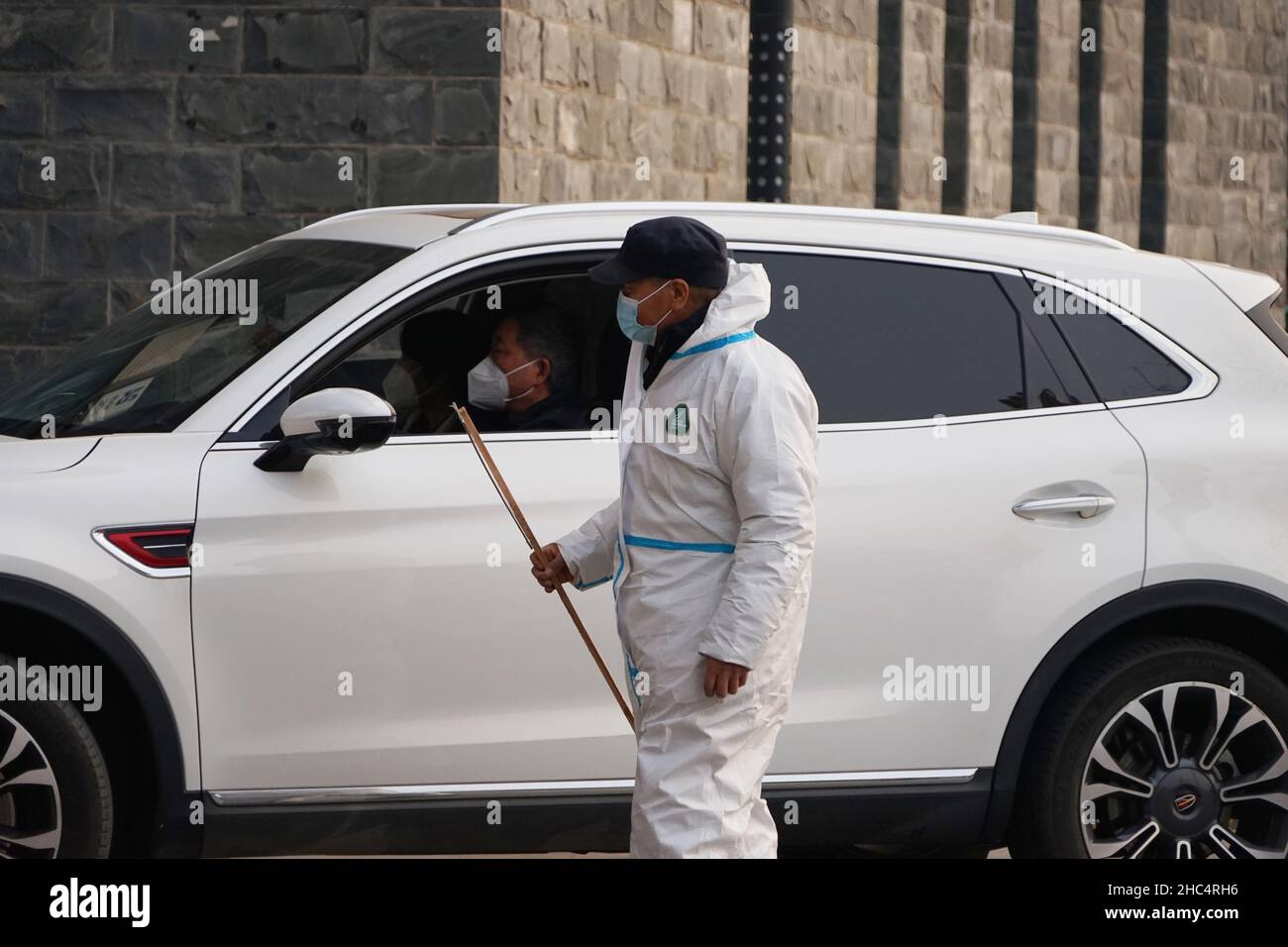 XI'AN, CHINA - DECEMBER 24, 2021 - A worker at the gate of the ...