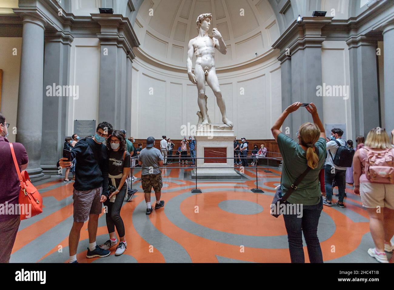 Tourists take pictures of Michelangelo's sculpture David. Galleria ...