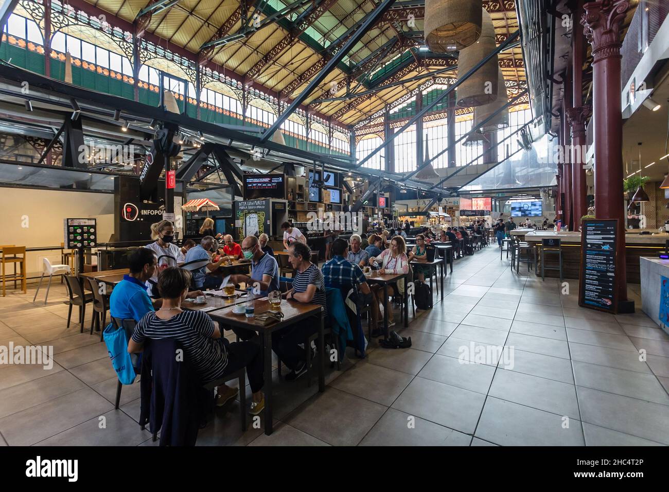 People are having drinks in a restaurant at Mercado Centrale, an indoor ...