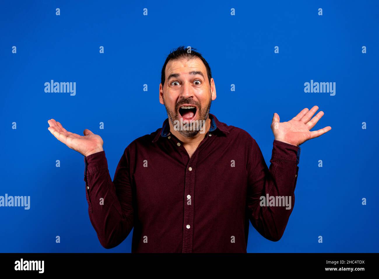 Handsome excited man happy smile looking at camera, showing open palm ...