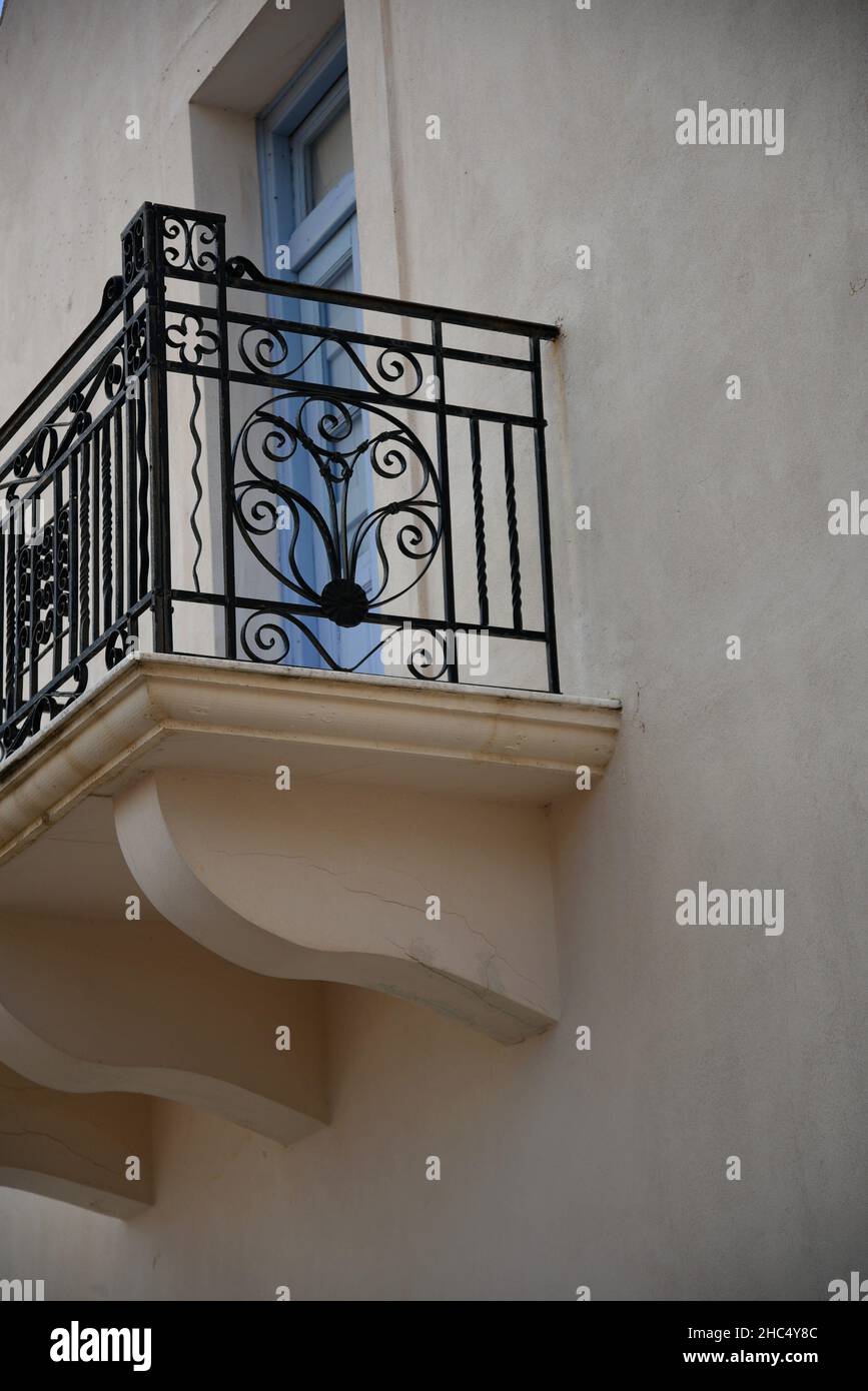 Old Neoclassical house balcony with a handcrafted wrought iron railing ...