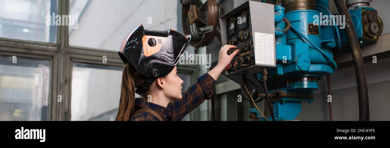 Side view of welder in mask switching welding machine in factory ...