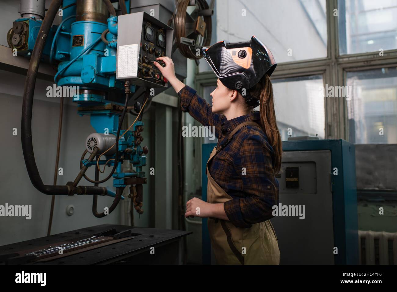 Side view of welder working with welding machine in factory Stock Photo ...