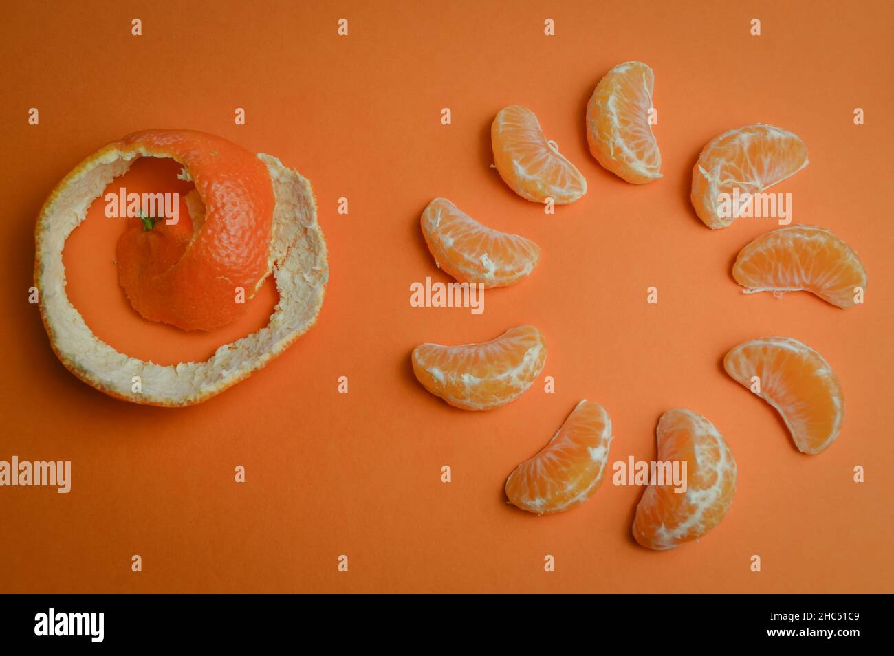 organic mandarin wedges arranged in a circle with the peel next to them ...