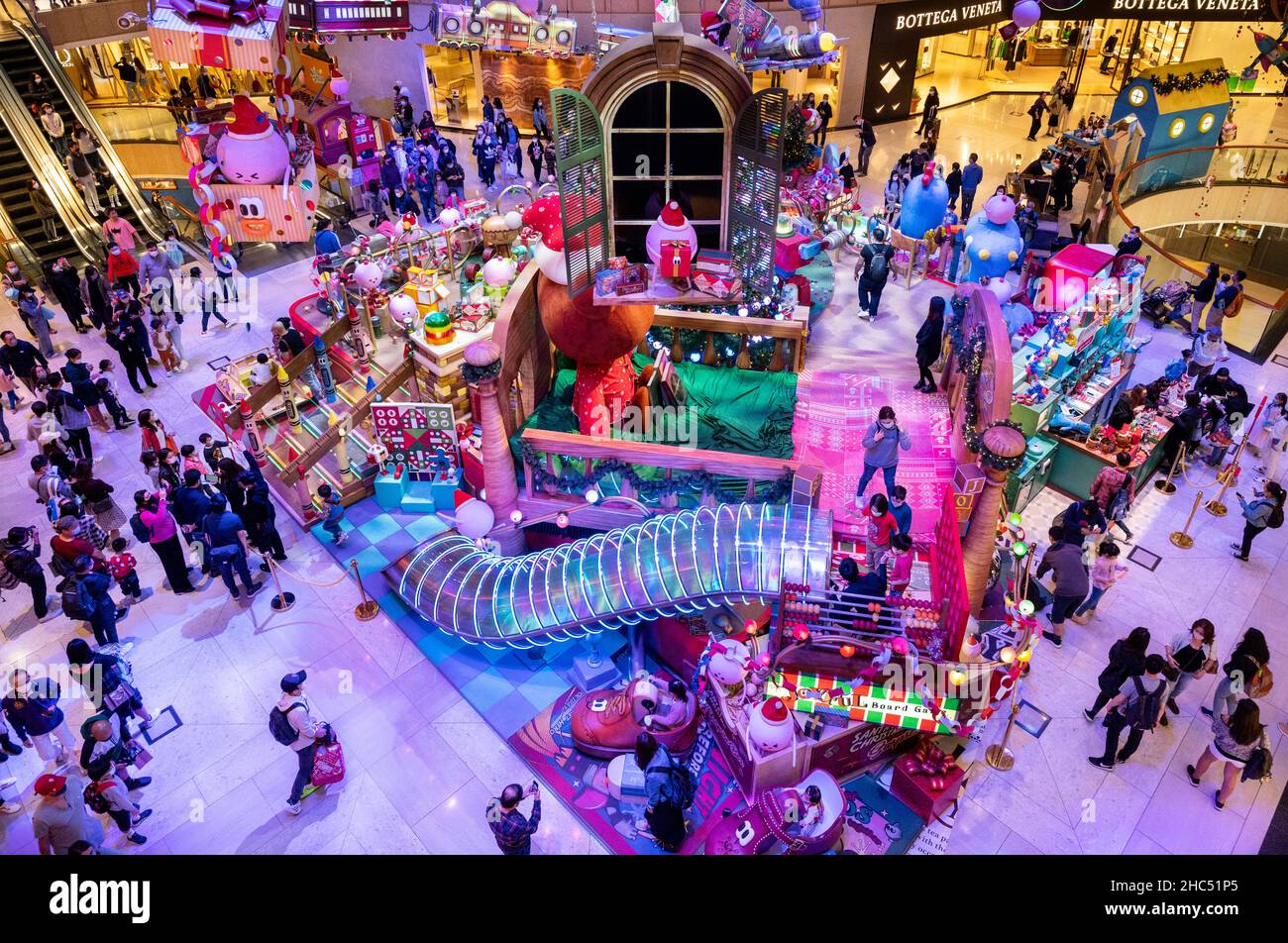 Families enjoy their evening at a shopping mall Christmas installation ...