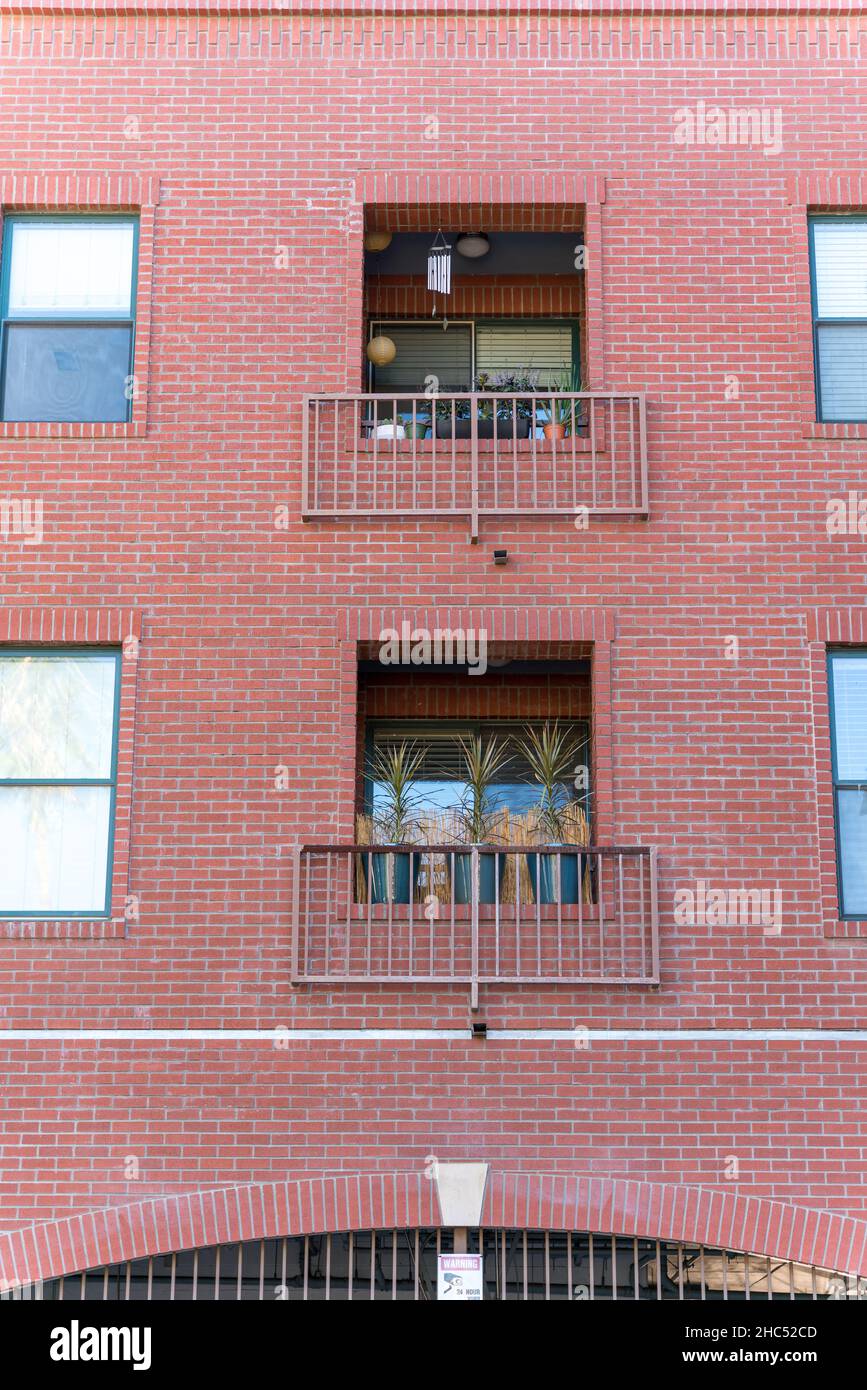 Vertical shot of a tall brick building with balcones Stock Photo - Alamy