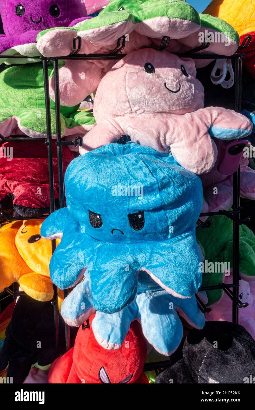 Plush toy octopus on a stand on the seafront on Brighton beach ...