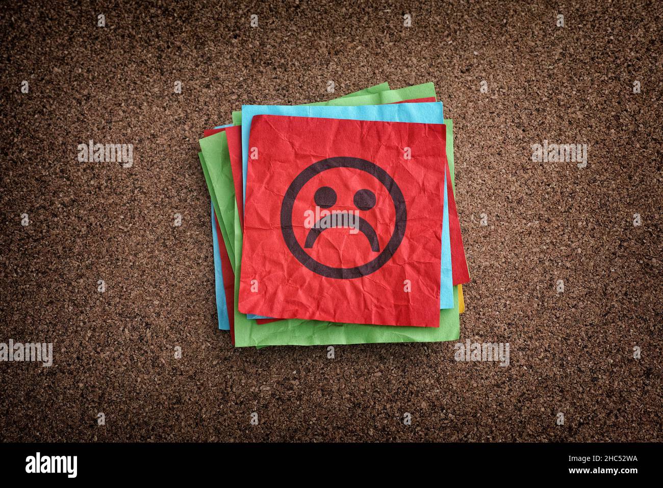 A stack of sticky notes with sad faces on them. Close up Stock Photo ...