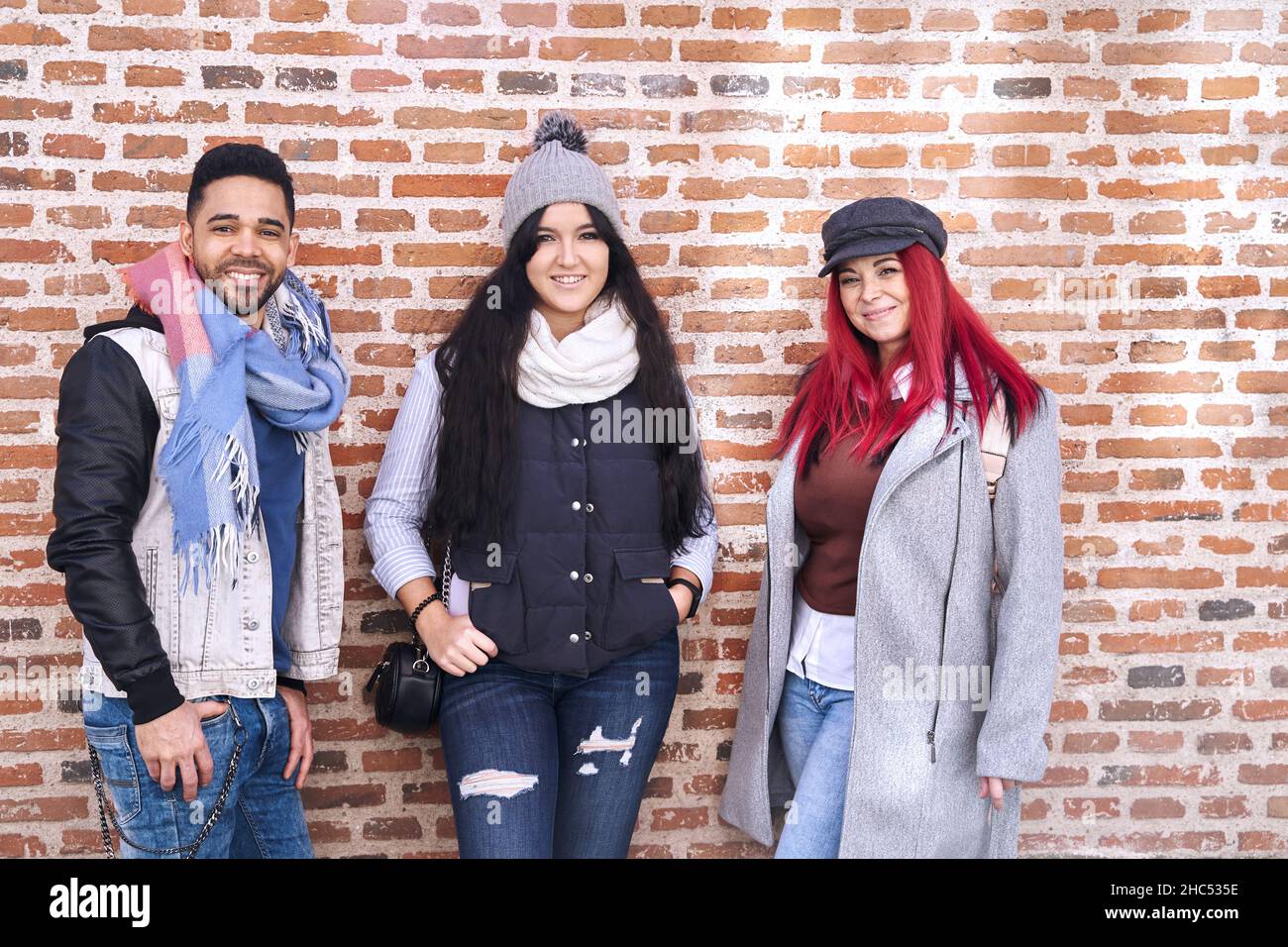 Positive multiracial young male and female friends wearing trendy ...