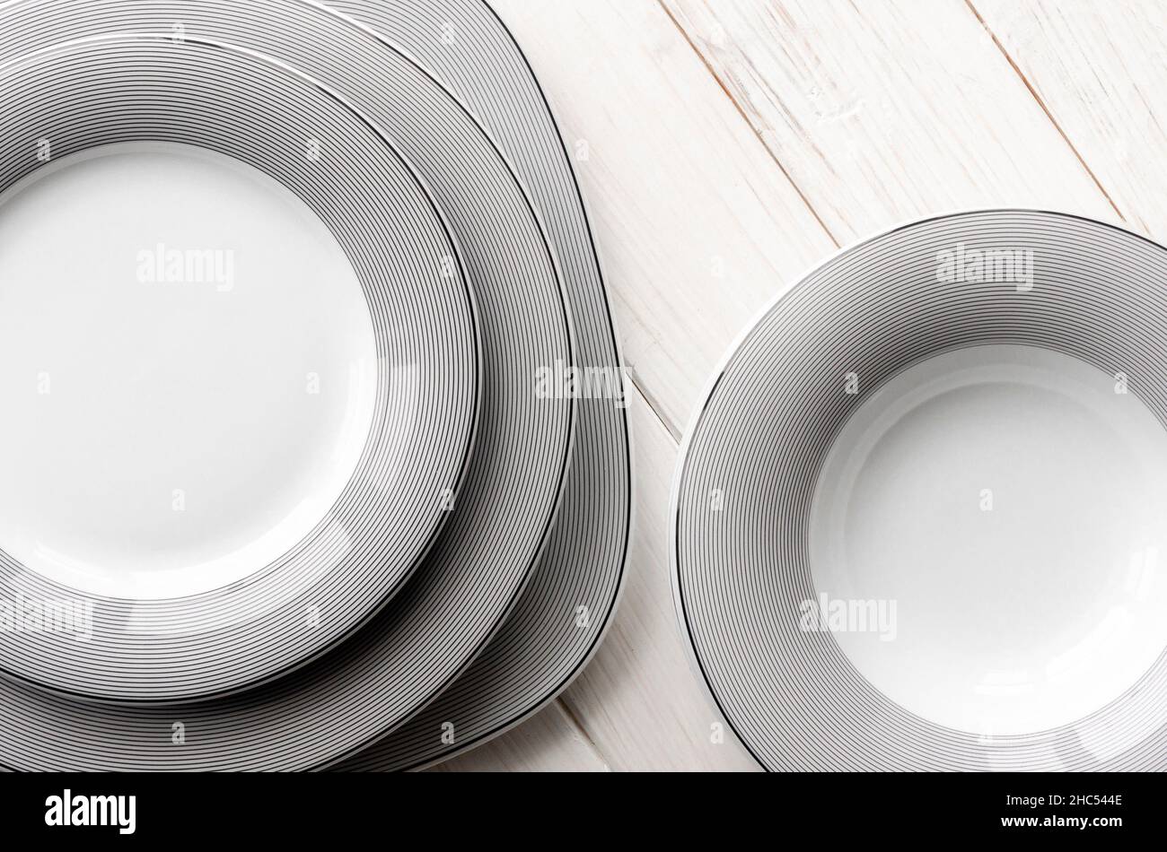 White round classical porcelain plates with a gray pattern stand on a ...