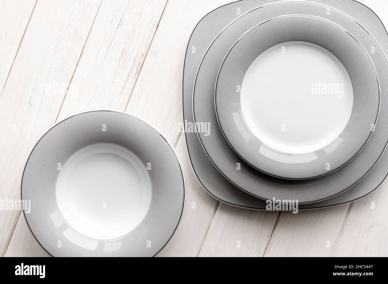 White round classical porcelain plates with a gray pattern stand on a ...