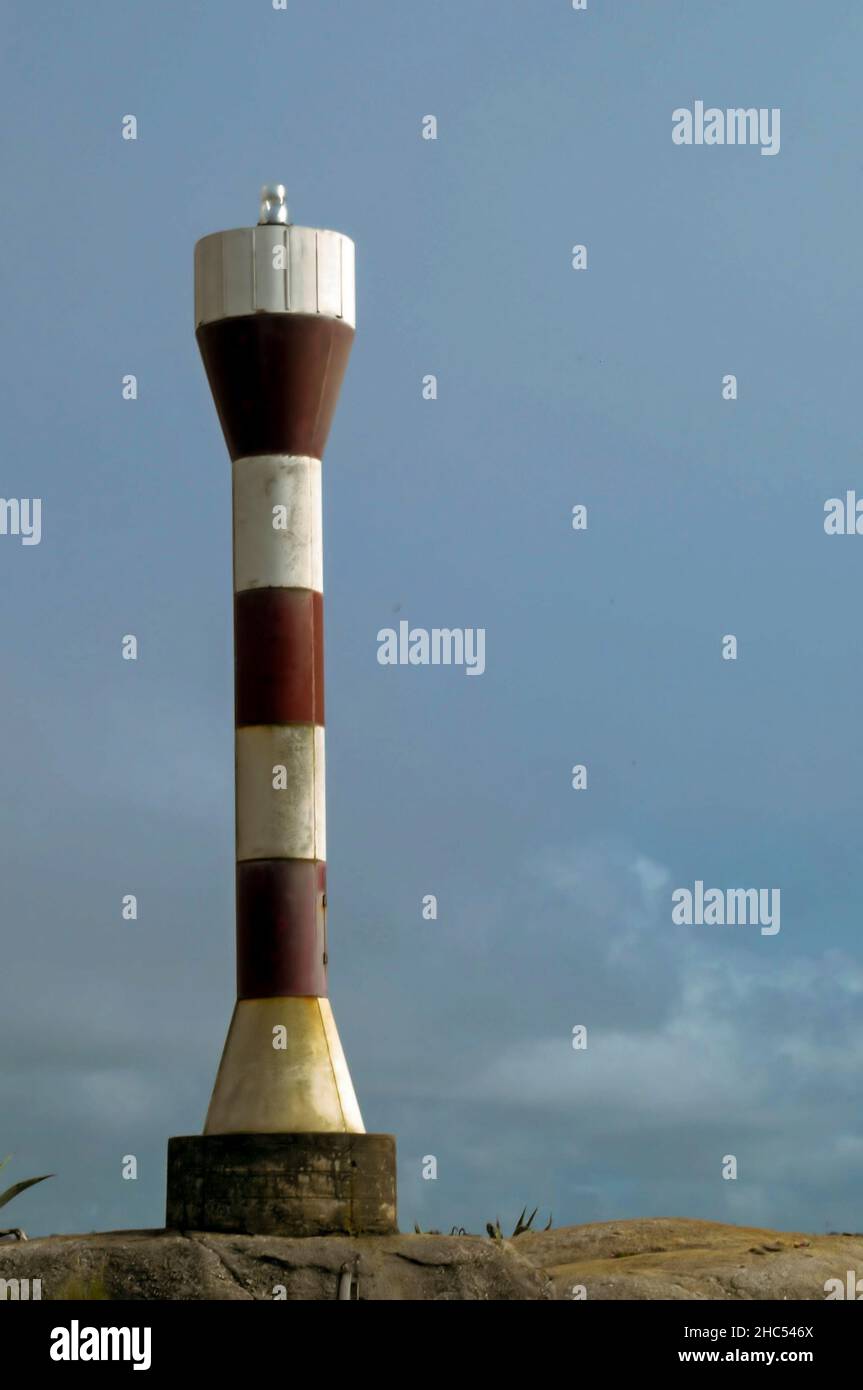 A lighthouse or light signaling tower located on the sea coast or on ...