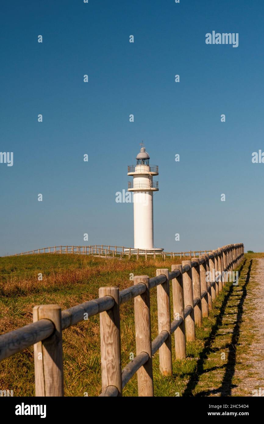 A lighthouse or light signaling tower located on the sea coast or on ...