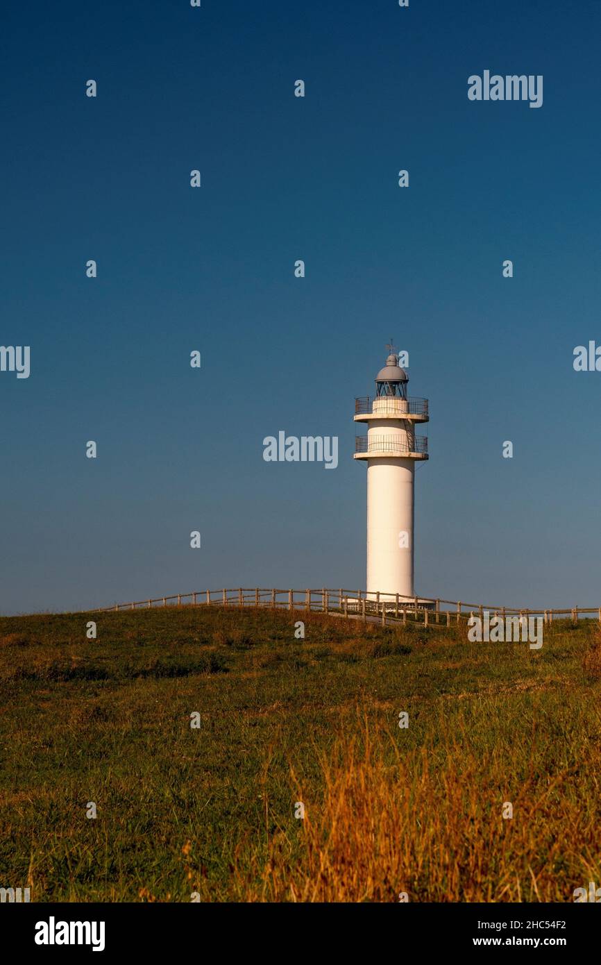 A lighthouse or light signaling tower located on the sea coast or on ...