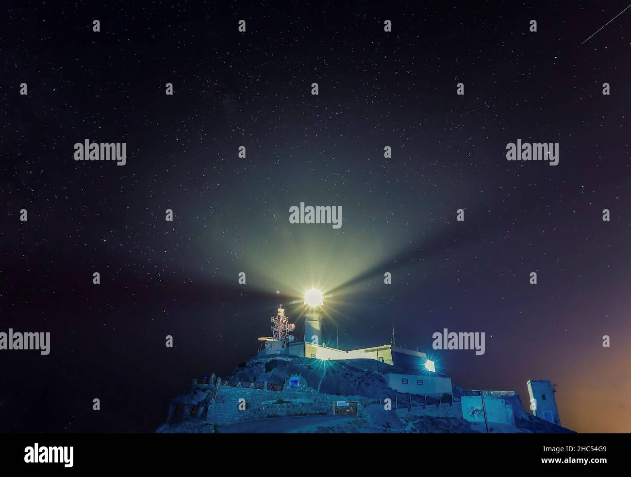 A lighthouse or light signaling tower located on the sea coast or on ...