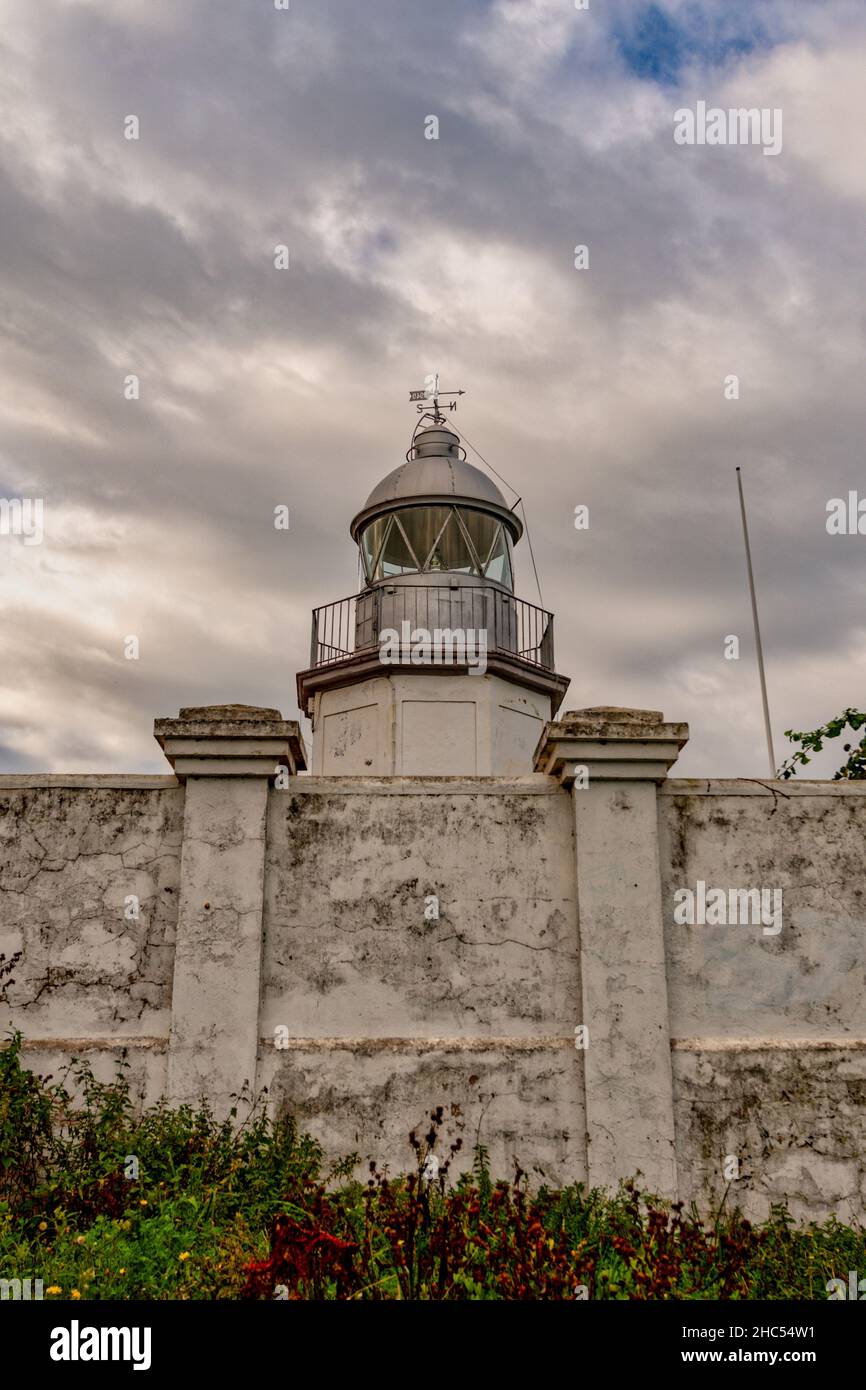 A lighthouse or light signaling tower located on the sea coast or on ...