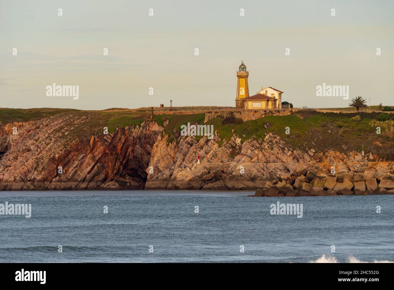 A lighthouse or light signaling tower located on the sea coast or on ...