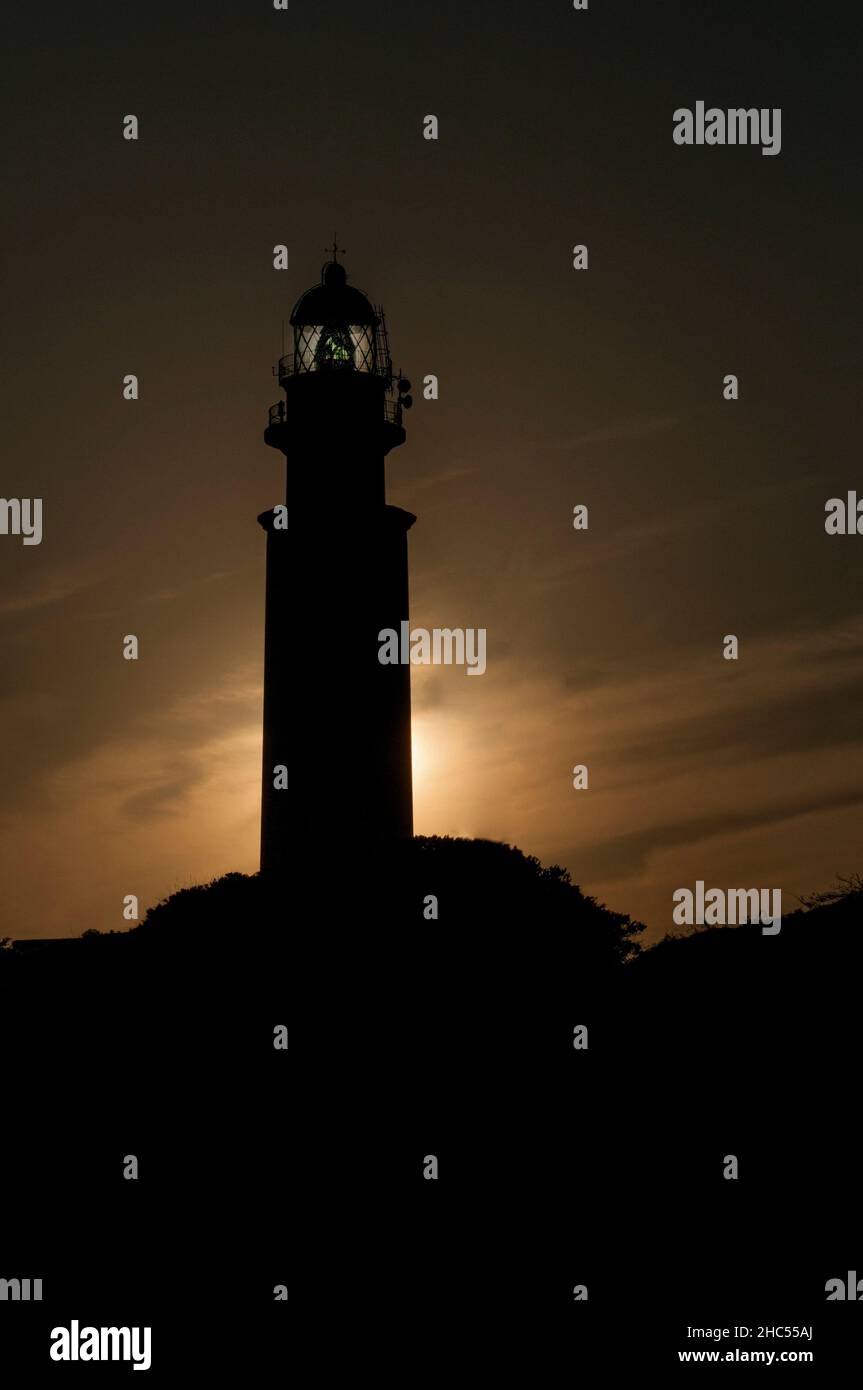 A lighthouse or light signaling tower located on the sea coast or on ...