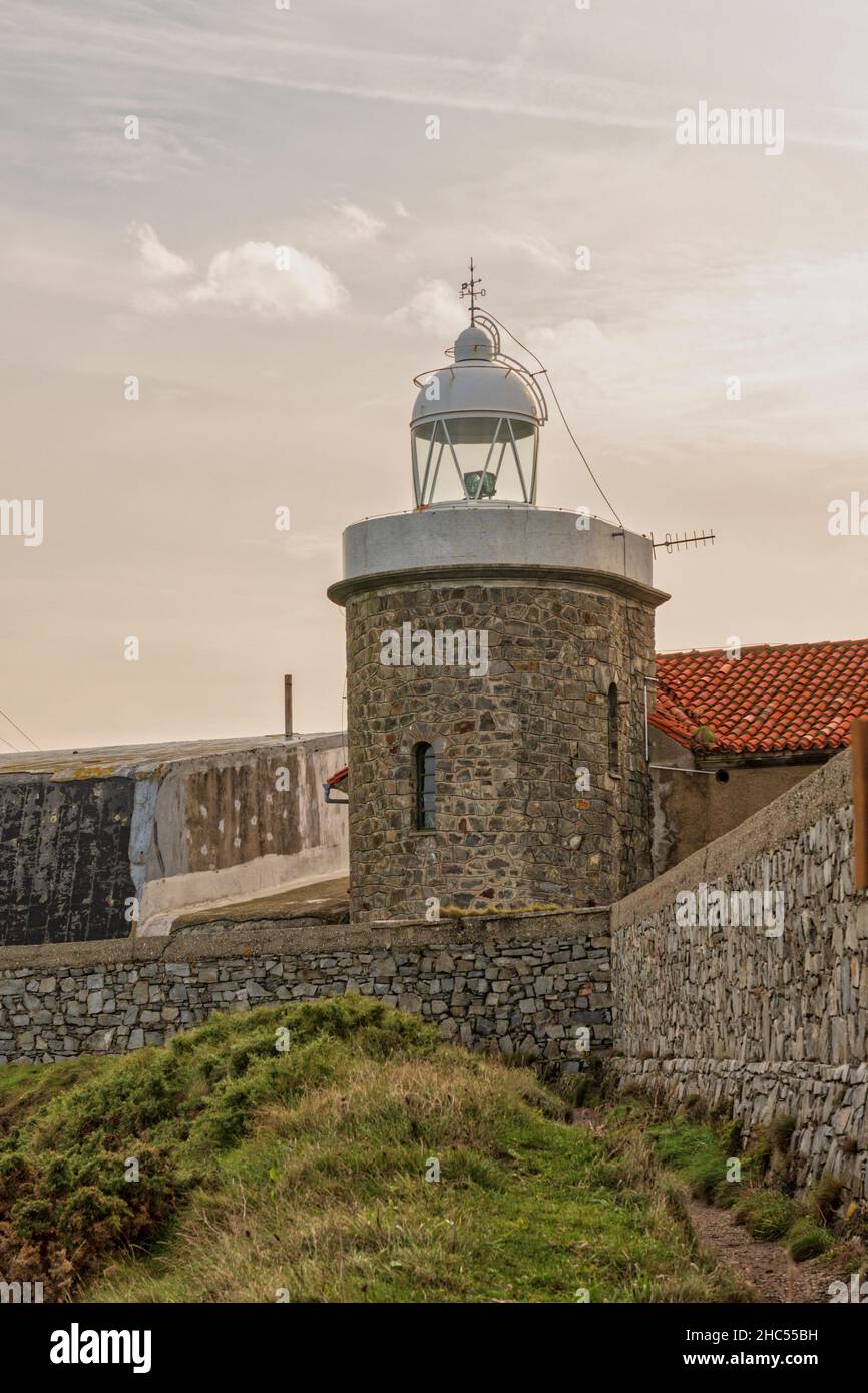A lighthouse or light signaling tower located on the sea coast or on ...