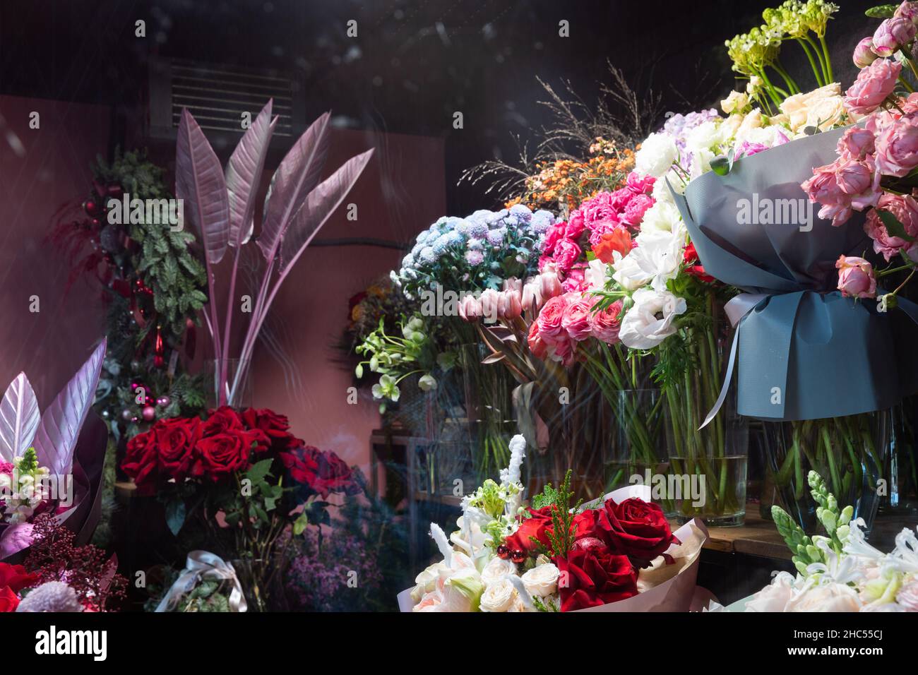 Luxurious bouquets on the shelves in the refrigerator cabinet of the ...