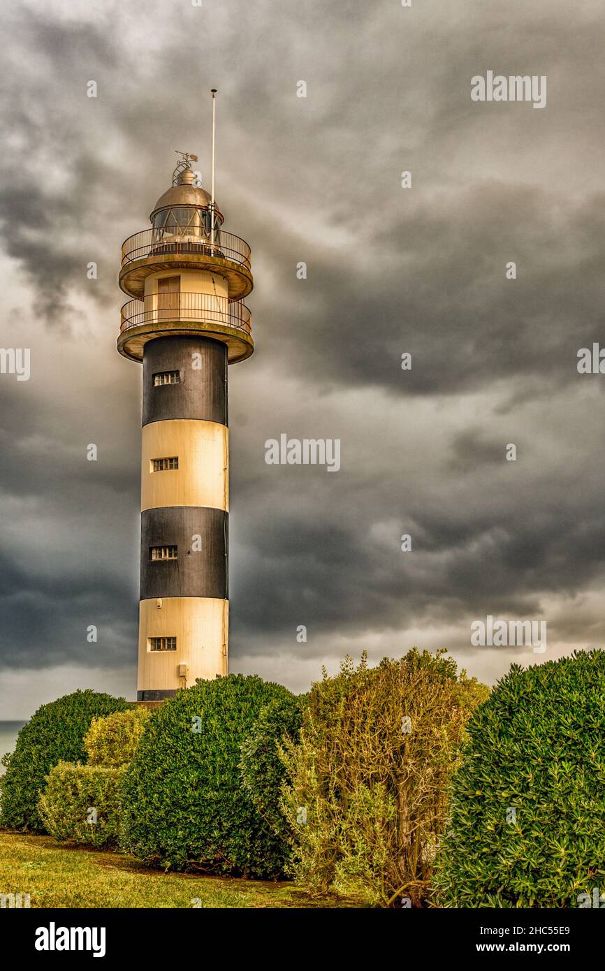 A lighthouse or light signaling tower located on the sea coast or on ...