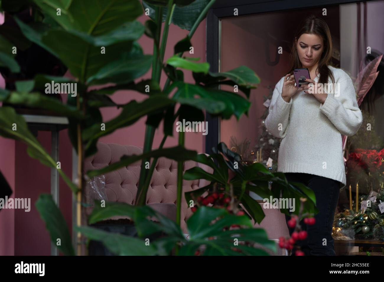 Minsk, Belarus - Dec 20, 2021: flower florist shop worker with phone ...