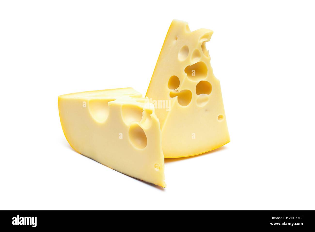 Two chunks of yellow cheese with big holes isolated on white background ...