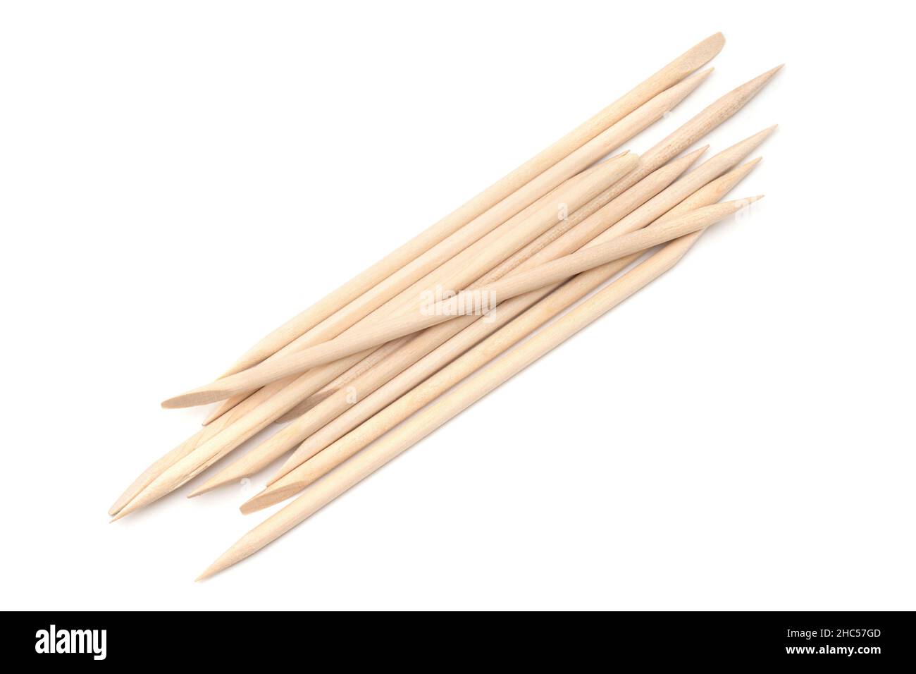 Pile of orange wood sticks isolated on white background. Manicure tools ...