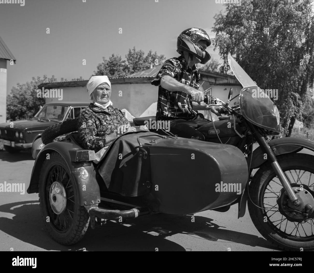 18th of July 2020, Russia, Altay, old woman in motorcycle sidecar black ...