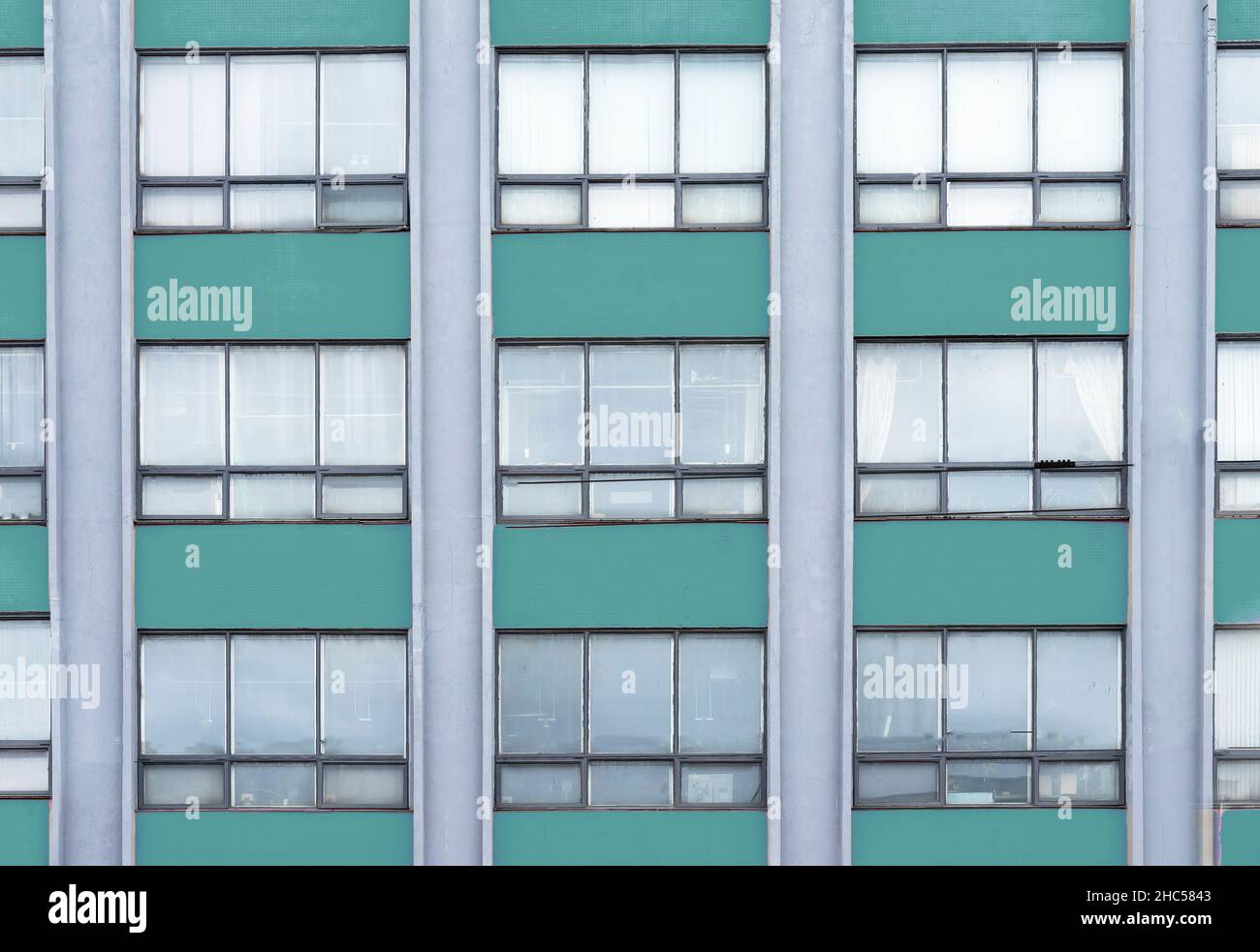 Green colored architecture building with windows Stock Photo - Alamy