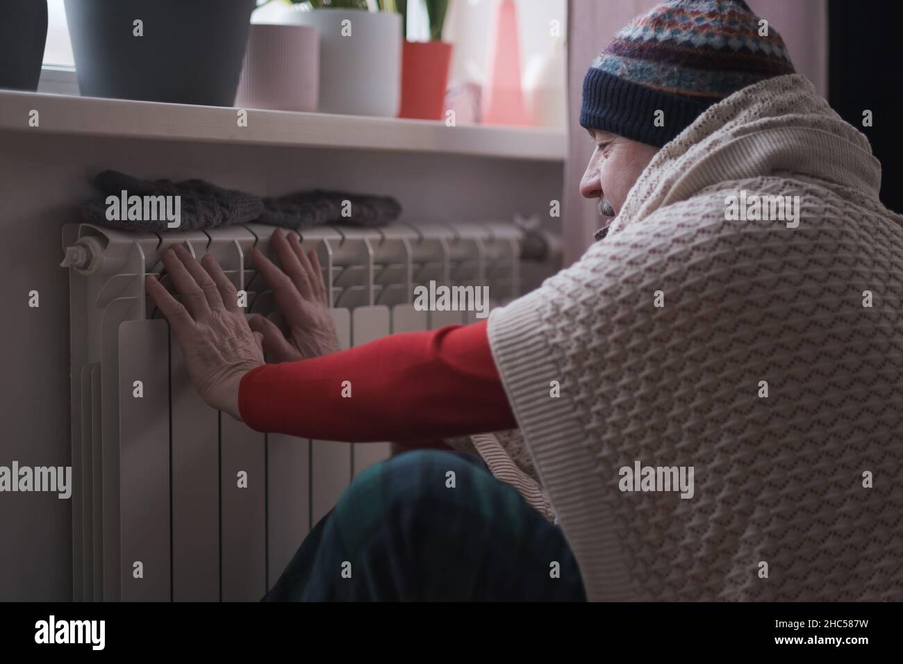 Man feeling cold at home with home heating trouble Stock Photo - Alamy