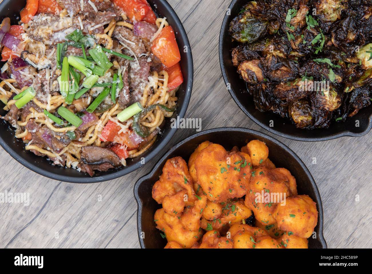 Overhead view of table feast of a variety of bar food choices with the ...