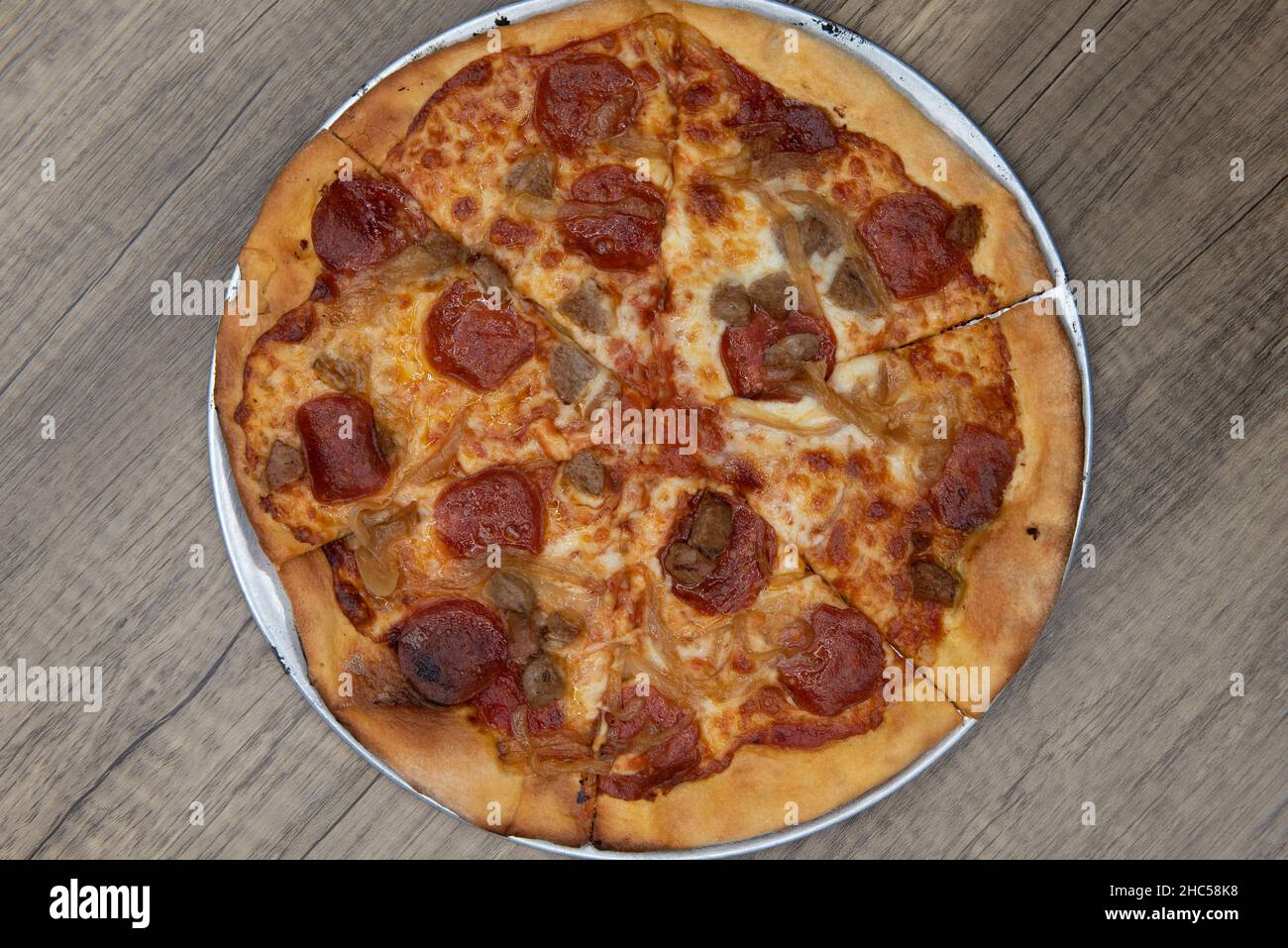 Overhead view of personal sized Italian pizza with melted cheese ...