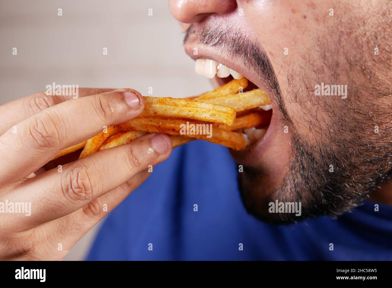 Man eating french fries hi-res stock photography and images - Alamy