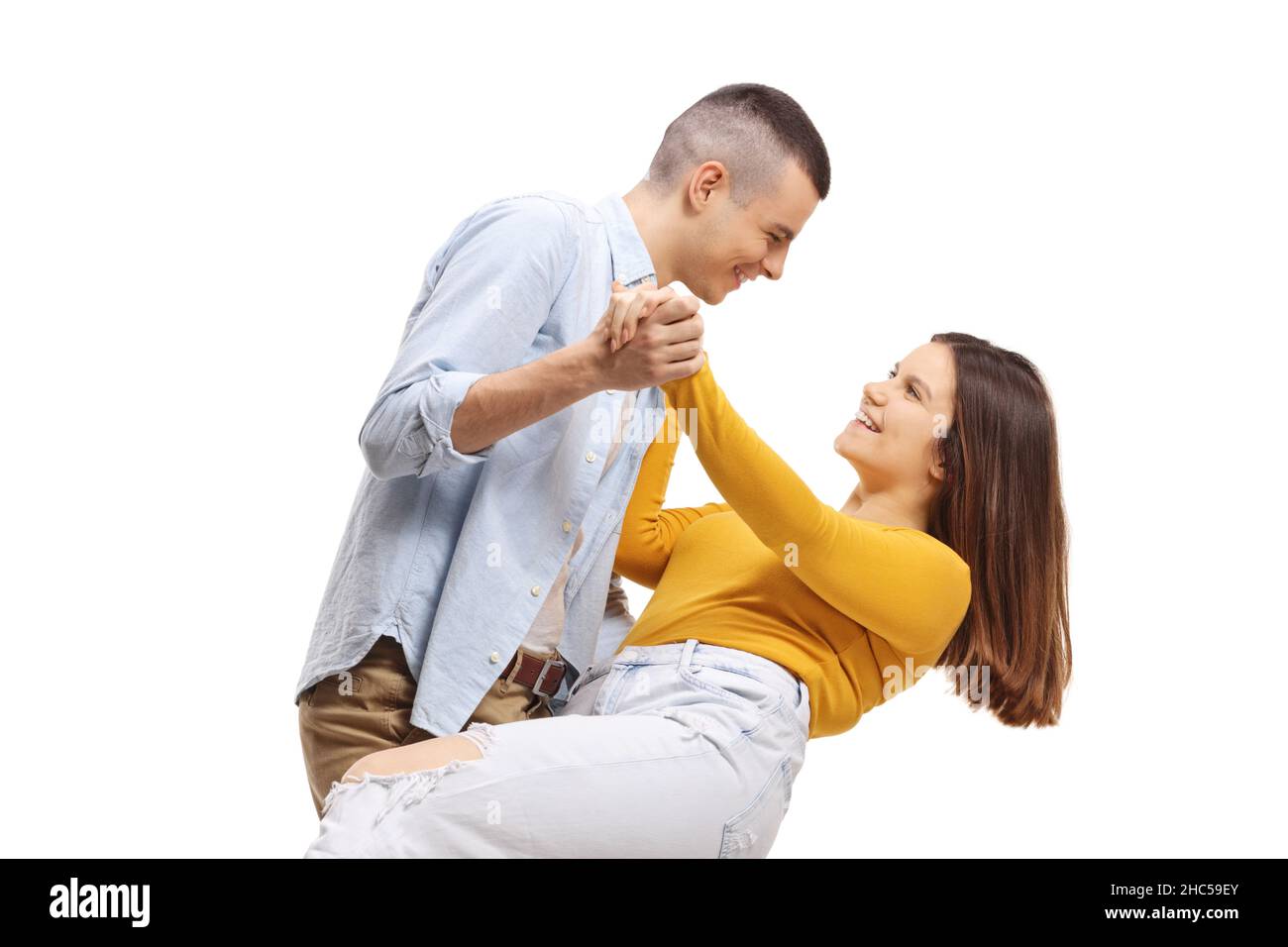 Happy casual young man and woman dancing tango and smiling isolated on ...