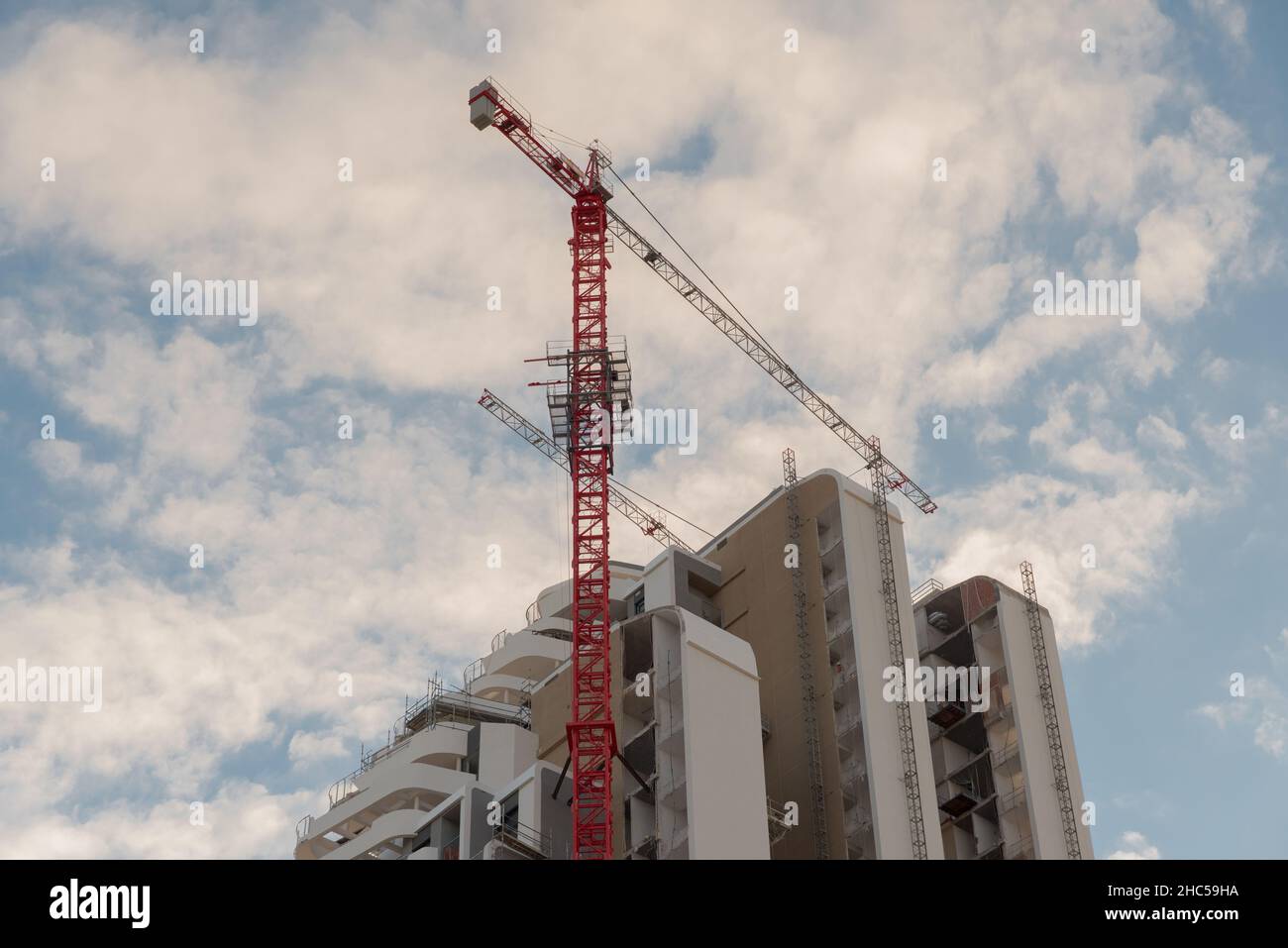Construction site background. Hoisting cranes and new multi-storey ...