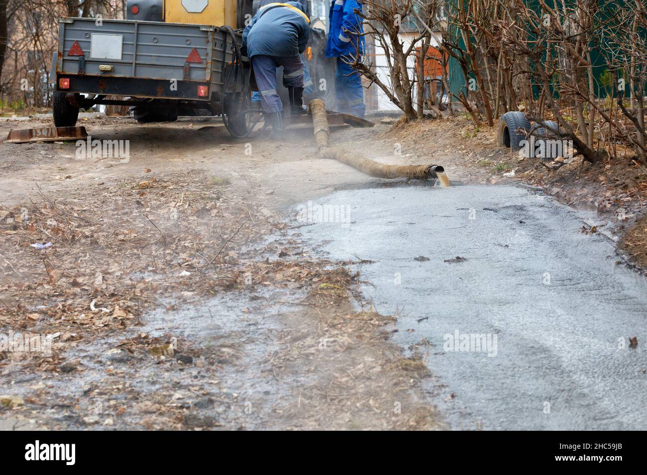 A breakthrough in a pipe with sewage water, a team of communal workers ...