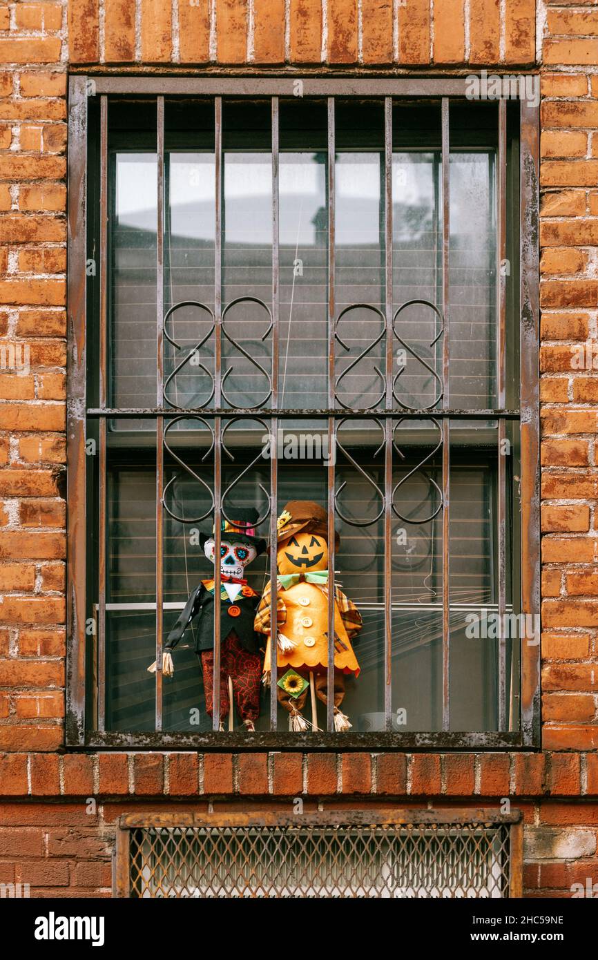 Vertical shot of small Halloween toys in a window grating Stock Photo ...