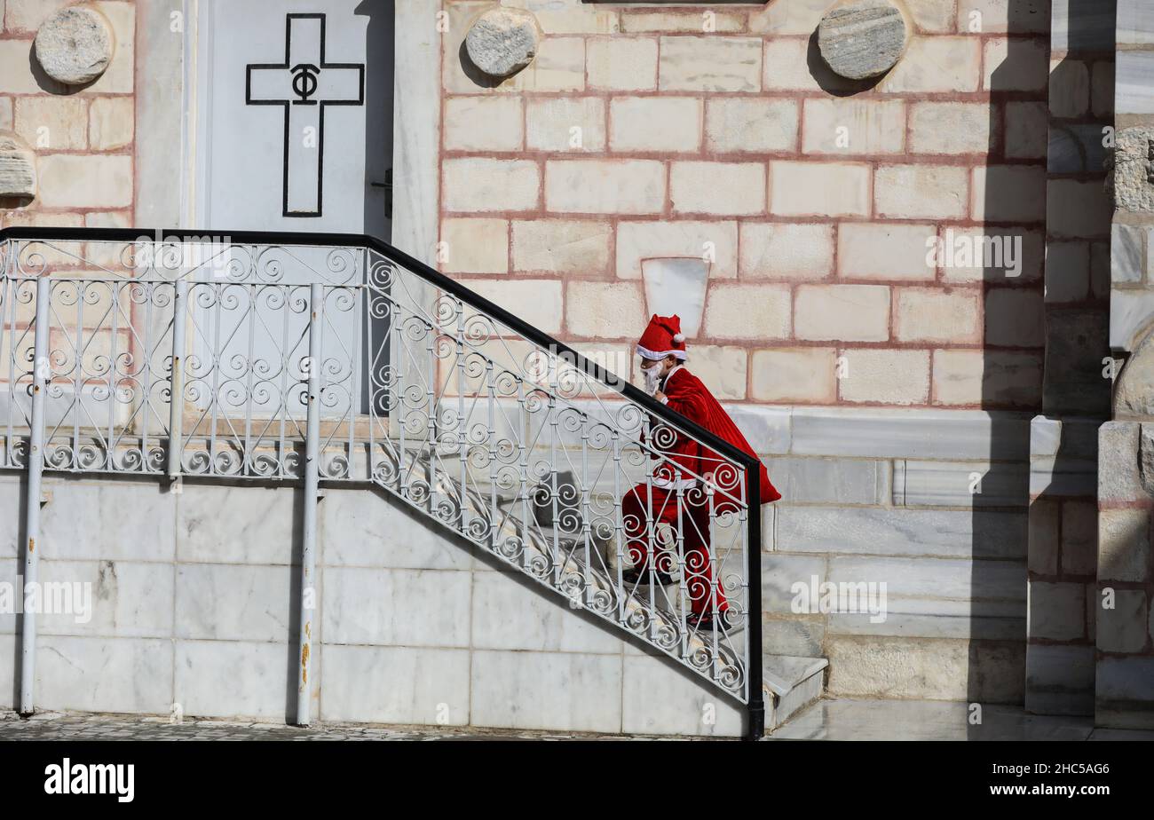 A Palestinian boy dressed as Santa Claus, seen climbing up the stairs ...