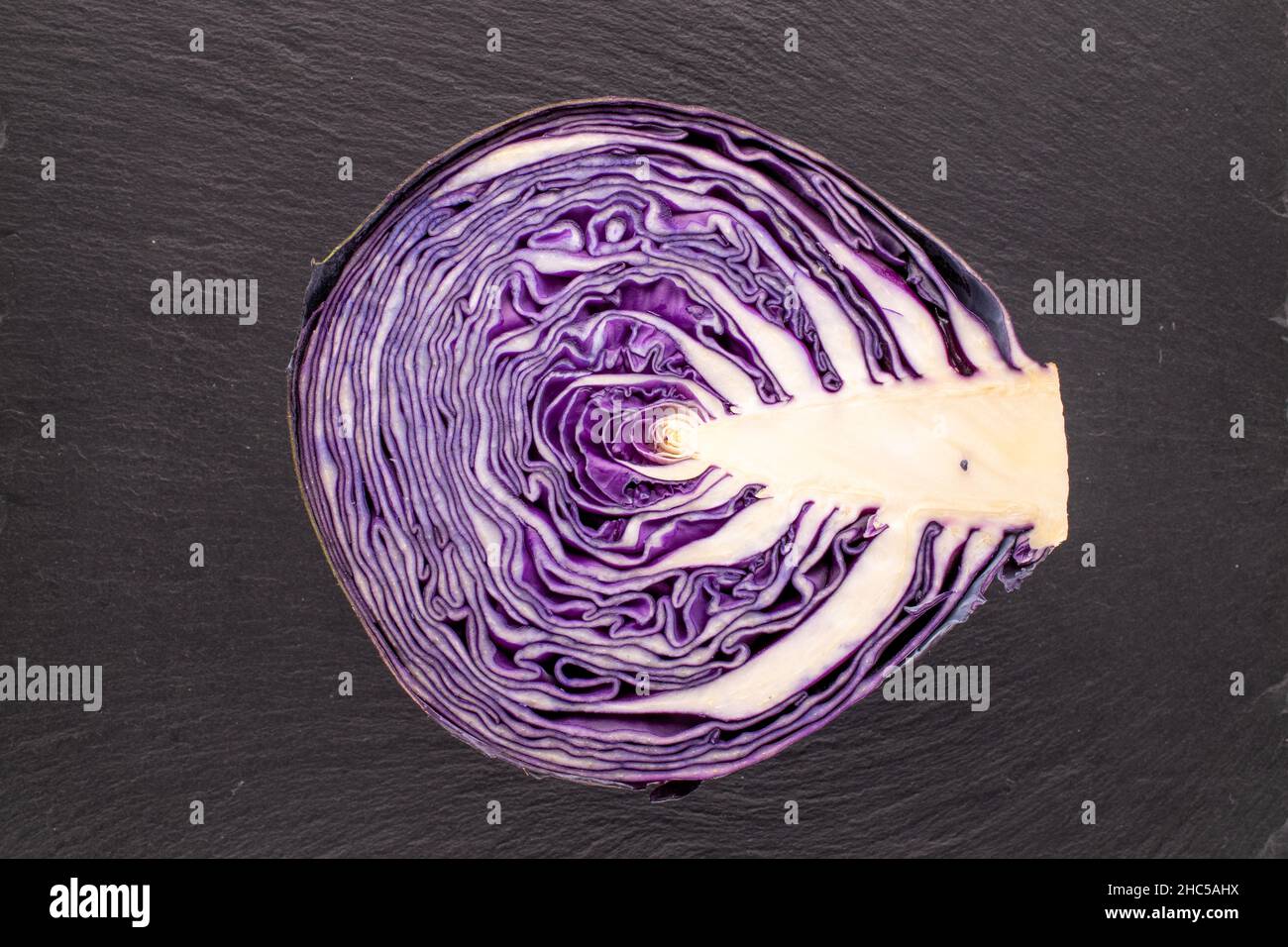 One half fresh red cabbage on a slate stone, close-up, top view Stock ...