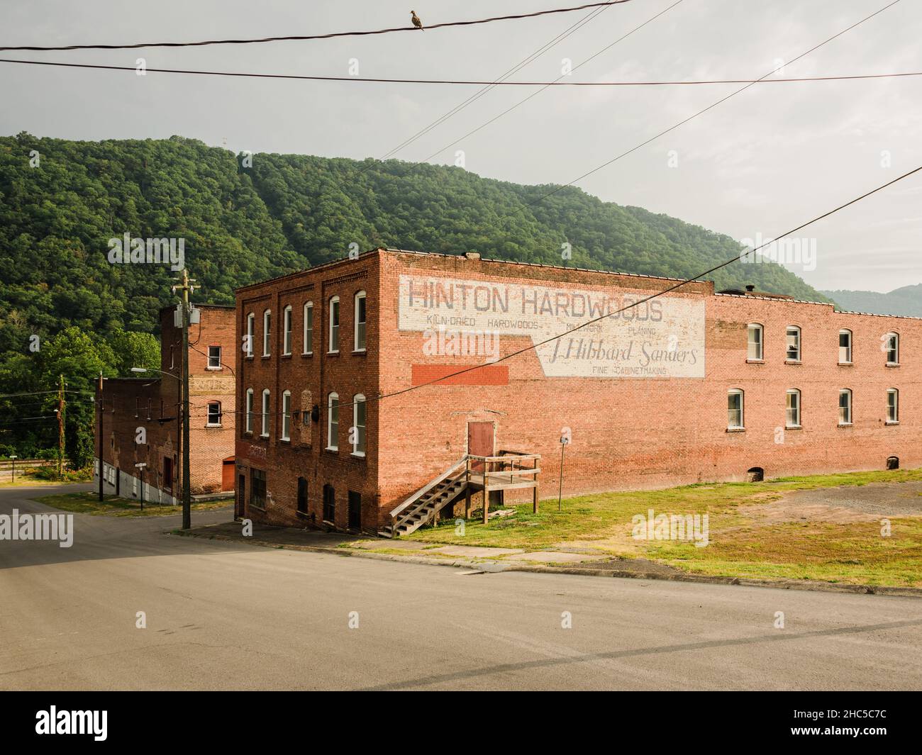 Old brick building with Hinton Hardwoods painted sign, in Hinton, West ...