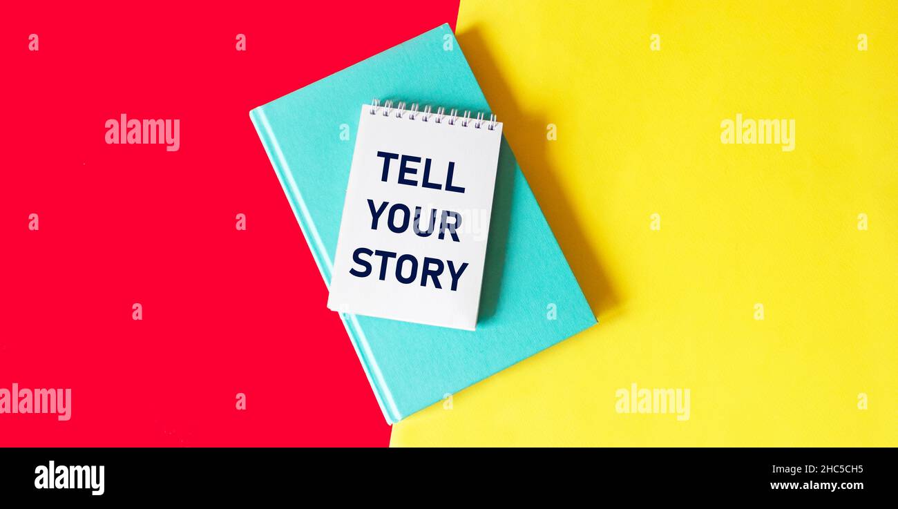 TELL YOUR STORY words on notepad and red and yellow background Stock ...