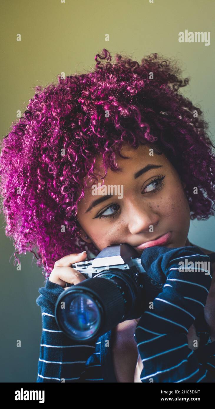 Girl who is dedicated to photography prepares from home to go to take ...