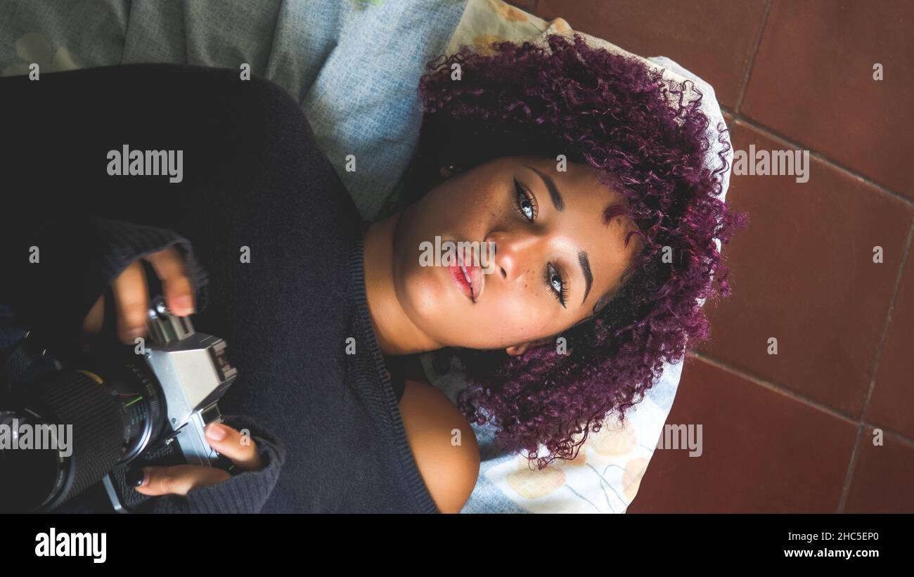Girl who is dedicated to photography prepares from home to go to take ...