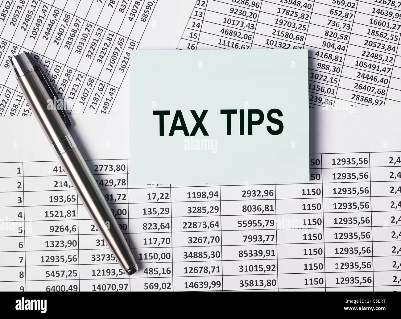 Tax tips concept. Word on business calculator Stock Photo - Alamy